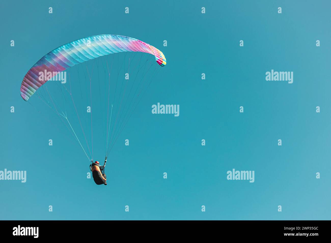 Paraglider in the sky. The sportsman flying on a paraglider Stock Photo ...