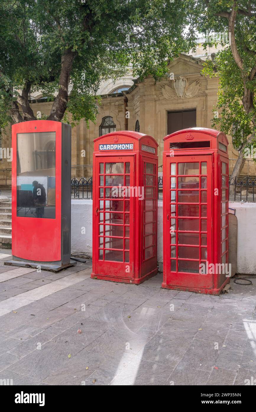 A pair of old red telephone booths in the historic center of Valletta ...