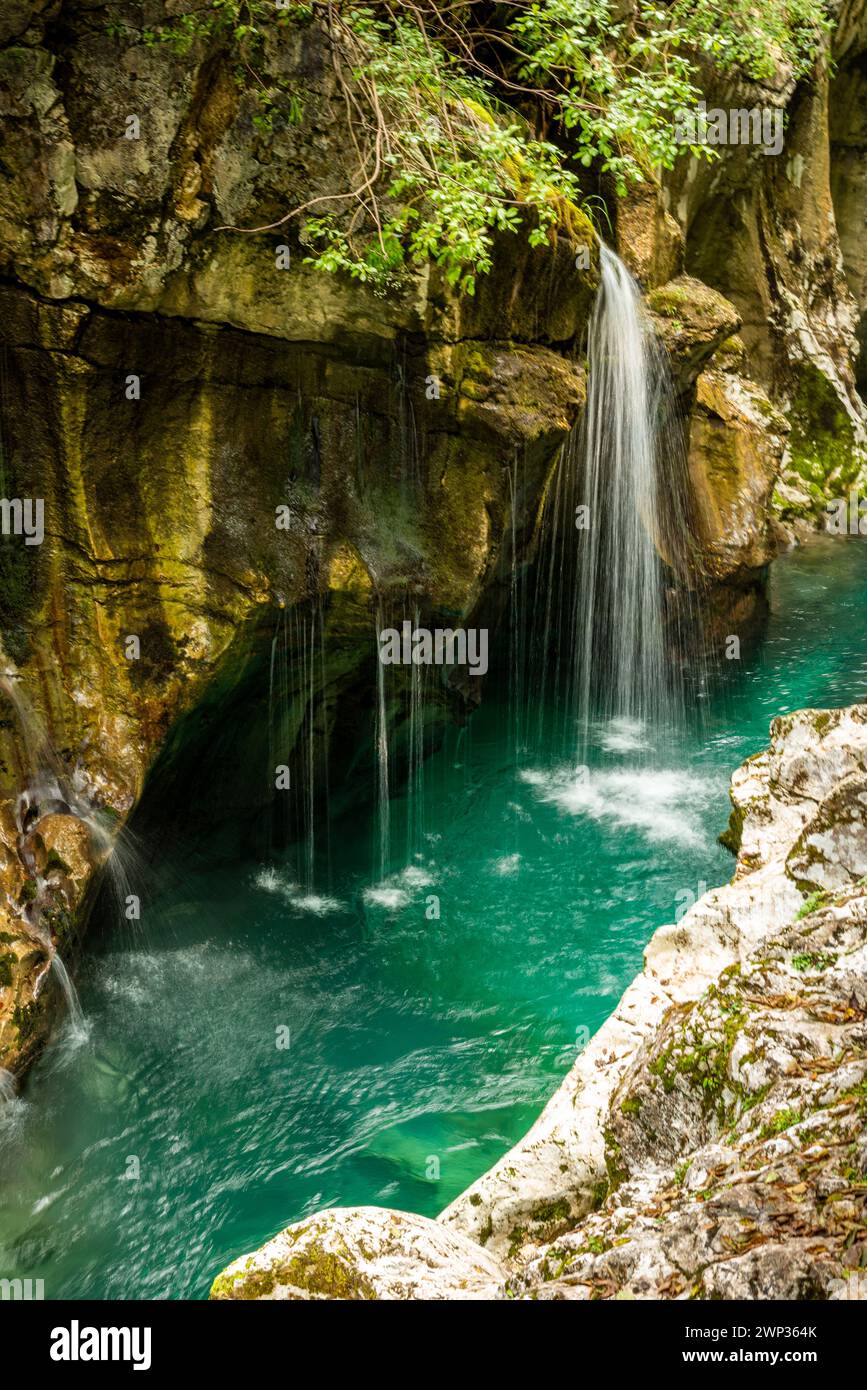 Landscape of Slovenia. A small waterfall flows into the turquoise ...
