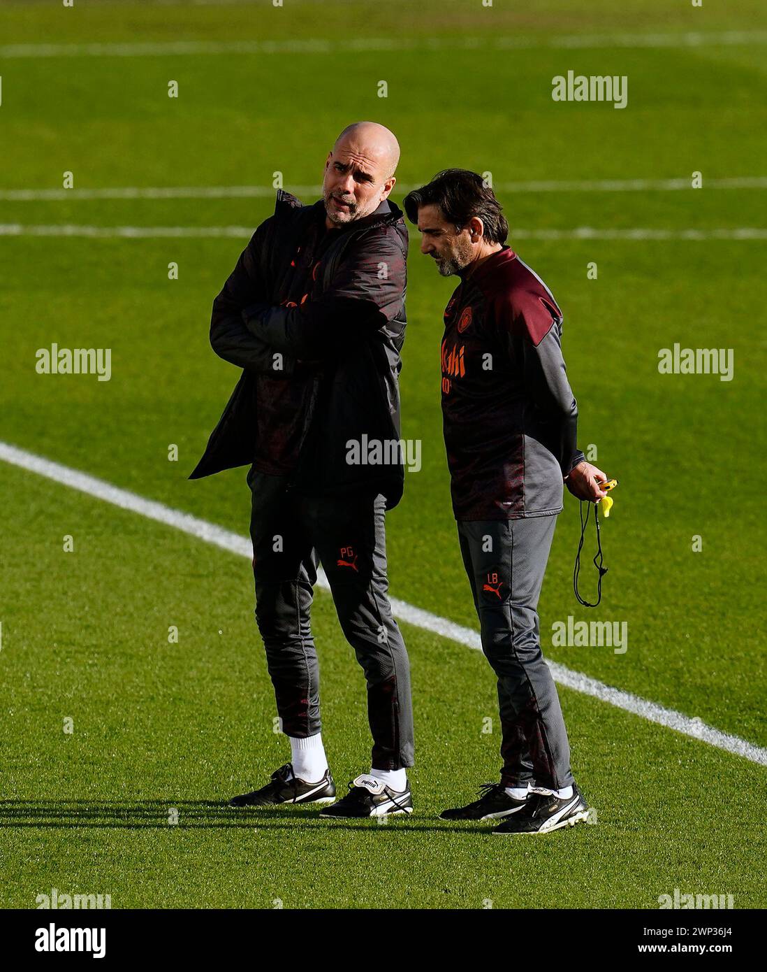 Manchester City manager Pep Guardiola (left) during a training session ...