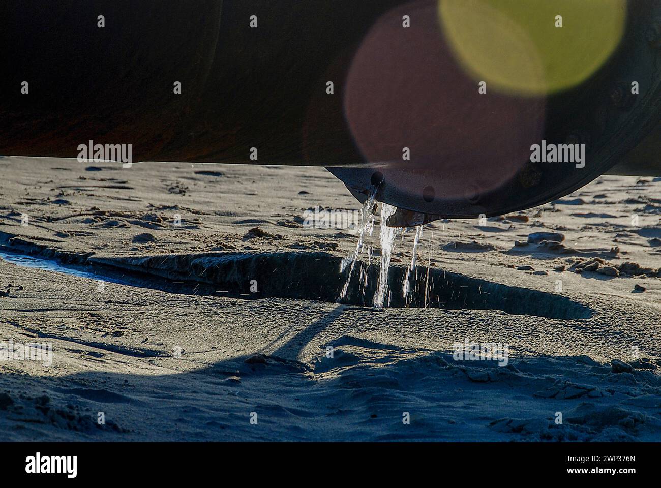 Water leaking out of a pipe Stock Photo - Alamy