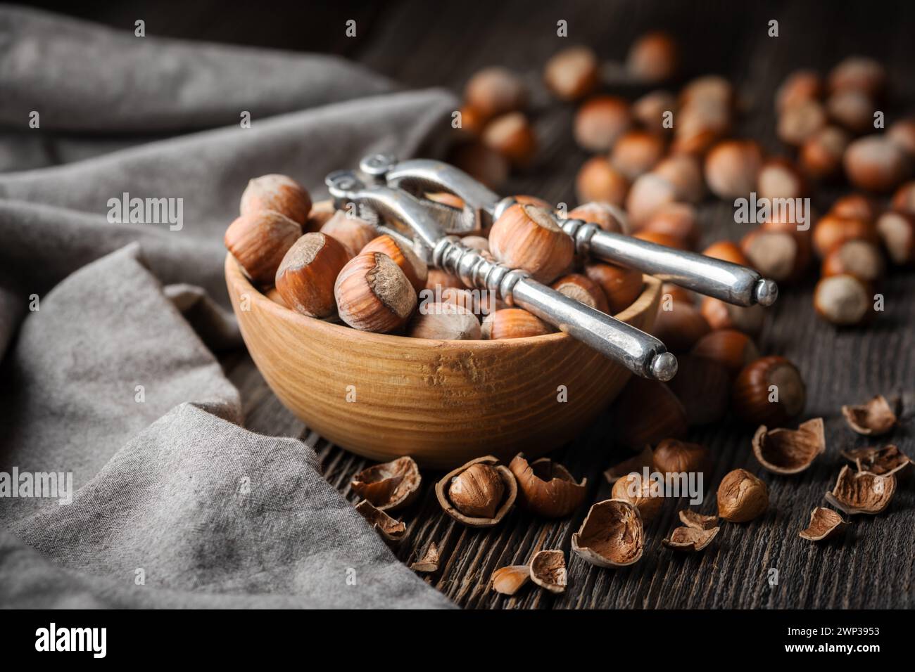 Vintage silver nutcracker on an aged wooden table, used to crack open ...