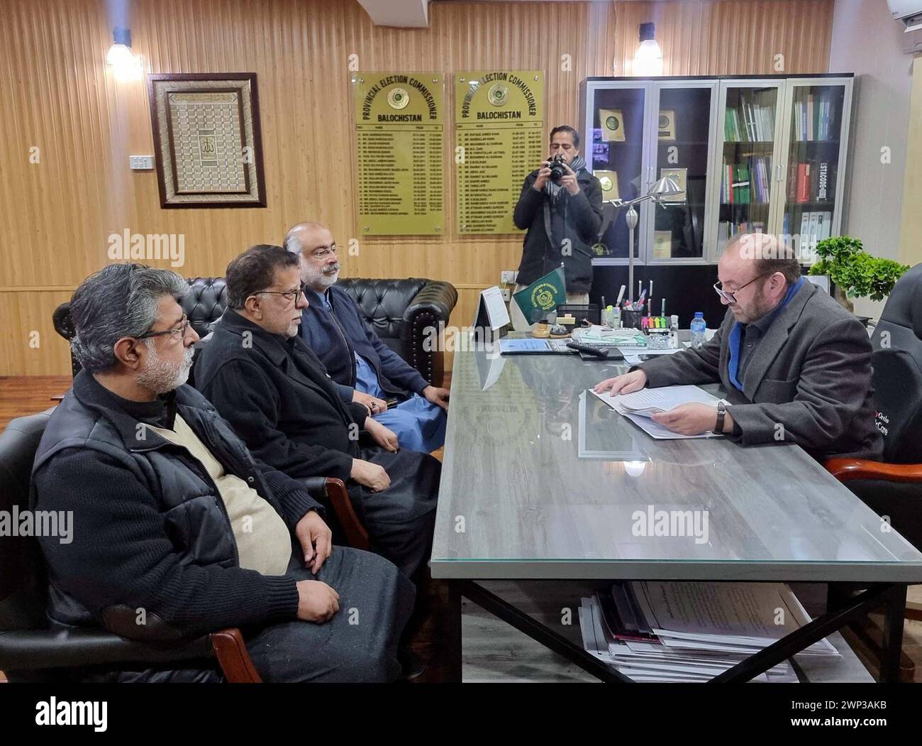 Provincial Election Commissioner Muhammad Farid Afridi is checking the papers of Senate ...