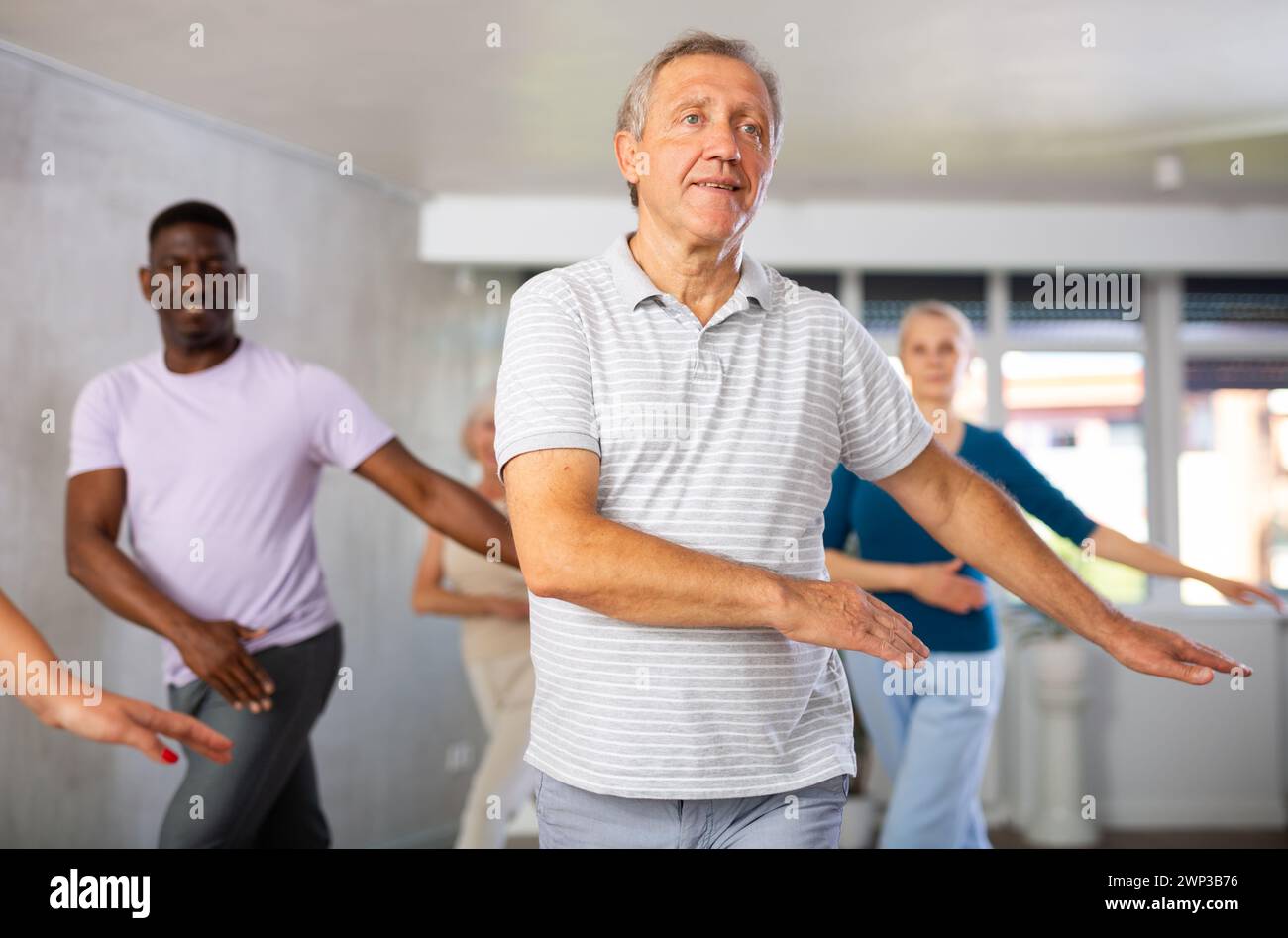 Elderly retired man dancing hip hop in studio practicing dance number ...
