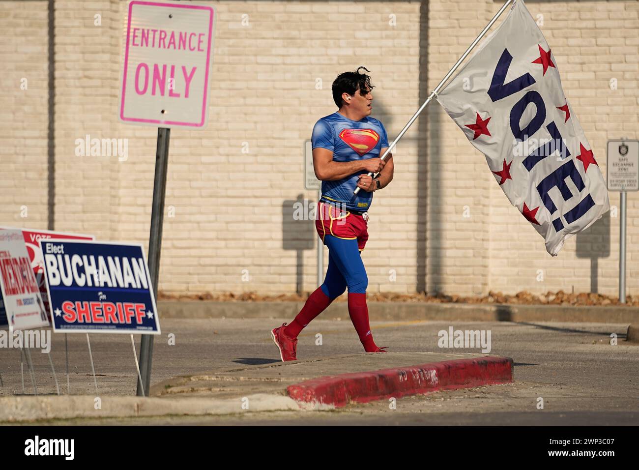 Dressed as Superman and holding a "Vote!" flag, Artist David Alcantar ...