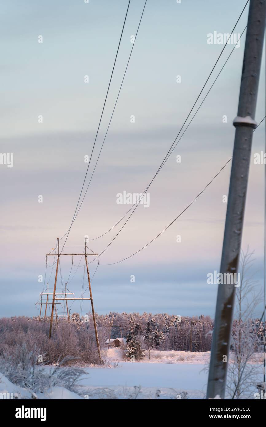 Snow-Covered Landscape With Power Lines and Electricity Poles at Dusk ...
