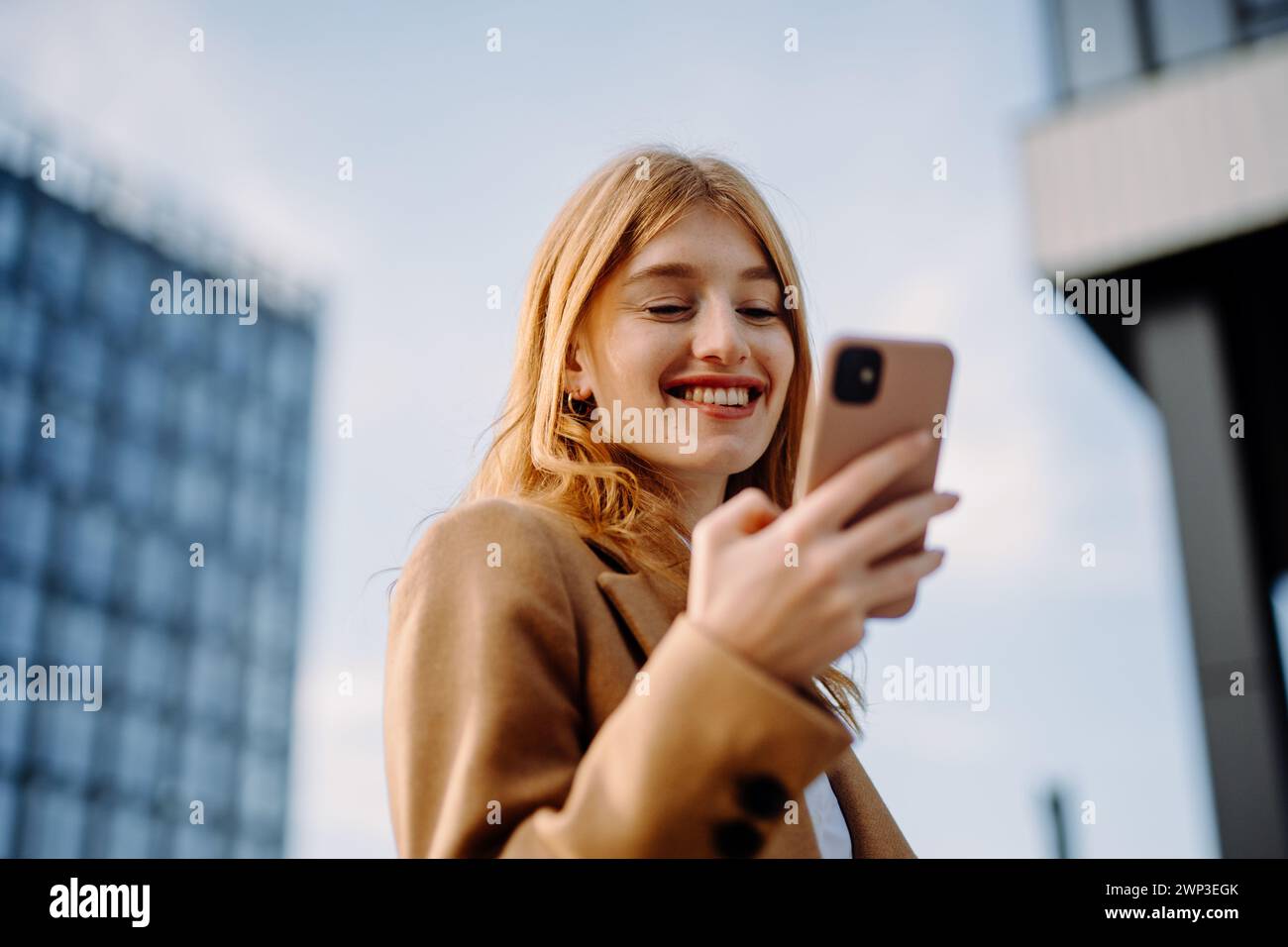 Corporate woman recording audio message while smiling and crossing from ...