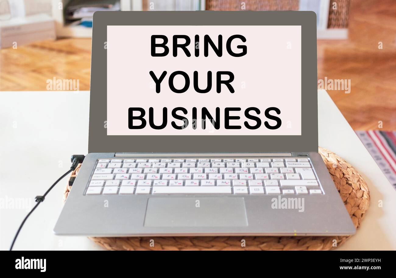 Bring your business online. text on laptop against office background ...