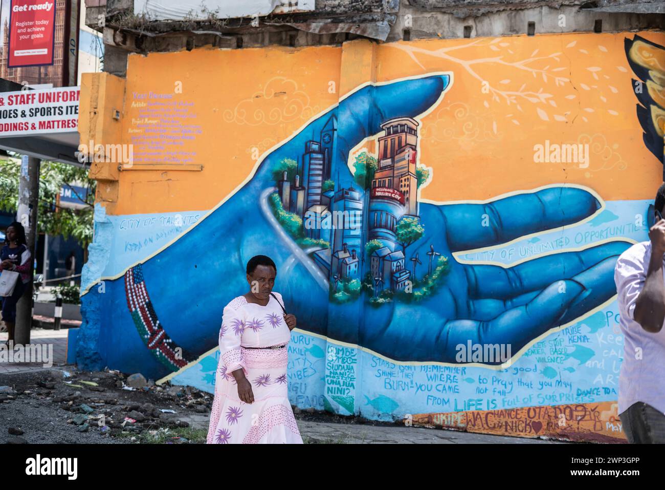 Nakuru, Kenya. 05th Mar, 2024. A woman walks past a mural depicting a ...
