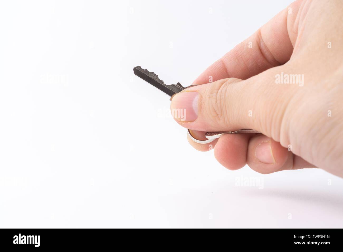 Hand a man holding a home key, isolated on white background Stock Photo ...