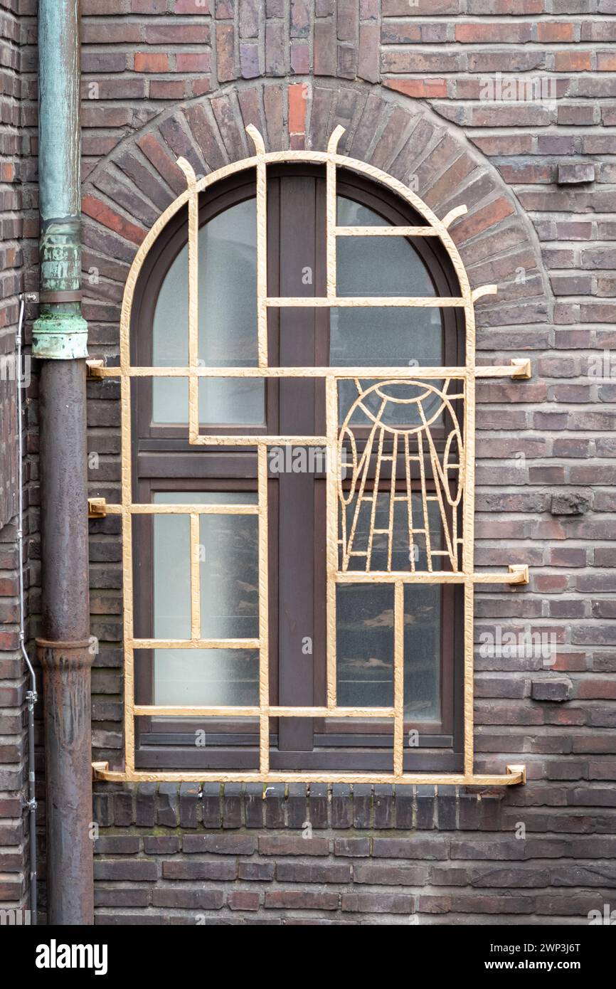 large window with gold-colored grille Stock Photo - Alamy