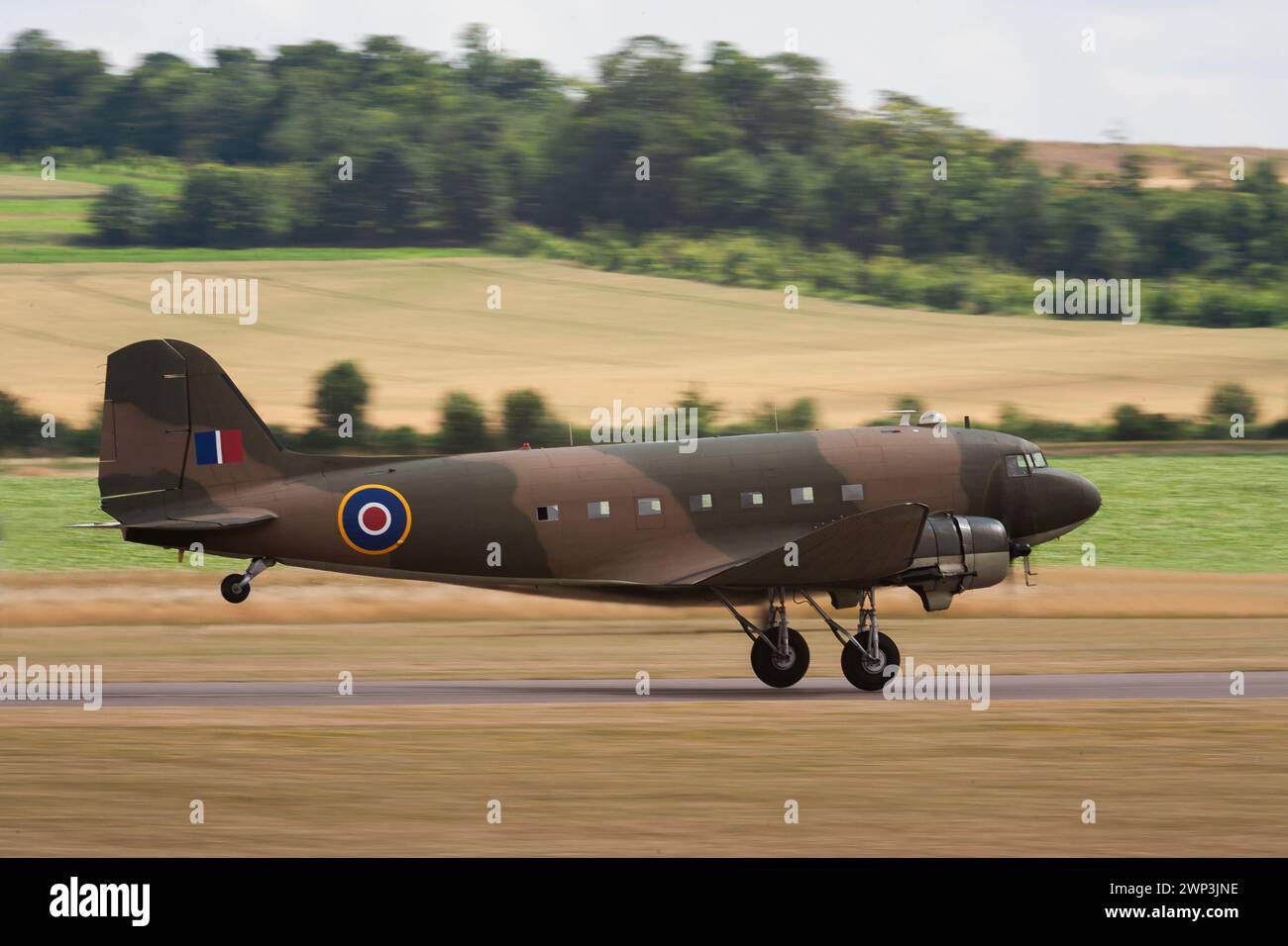 World War Two airplane 1942 C-47A Douglas Dakota in RAF colours landing at an airfield Stock ...