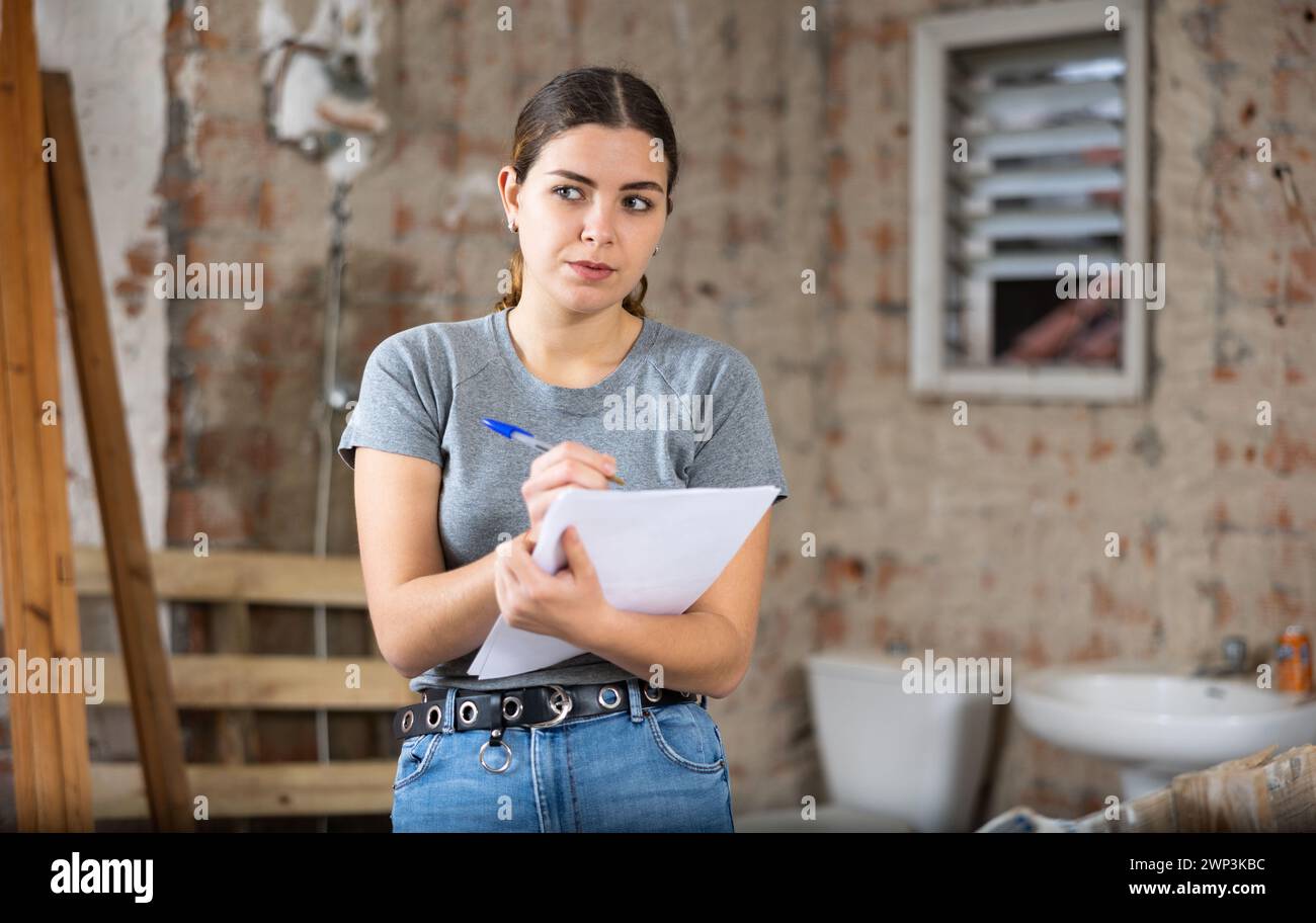Woman inspecting construction site checking hi-res stock photography ...