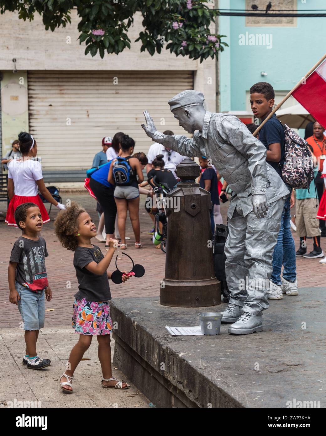 Two small children watch a mime perform in the colonial sector of Santo ...