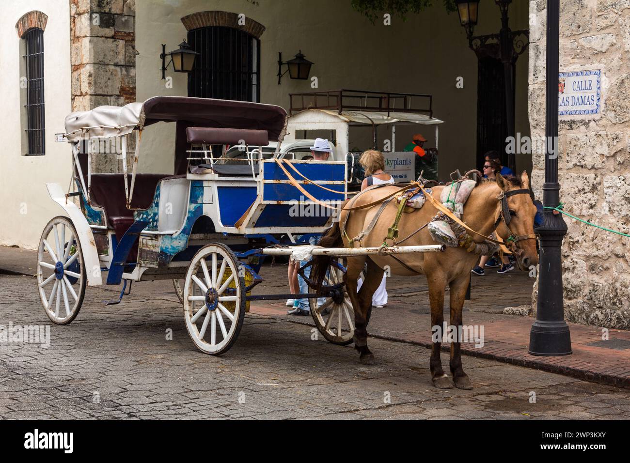 Painted horse-drawn carriage waiting for passengers in the old Colonial ...