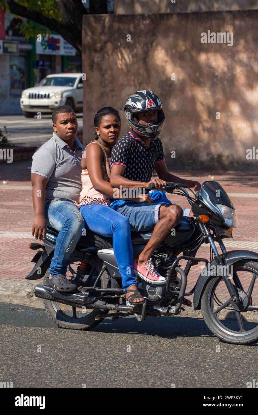 Three people riding together on a motorcycle in Santo Domingo in the ...