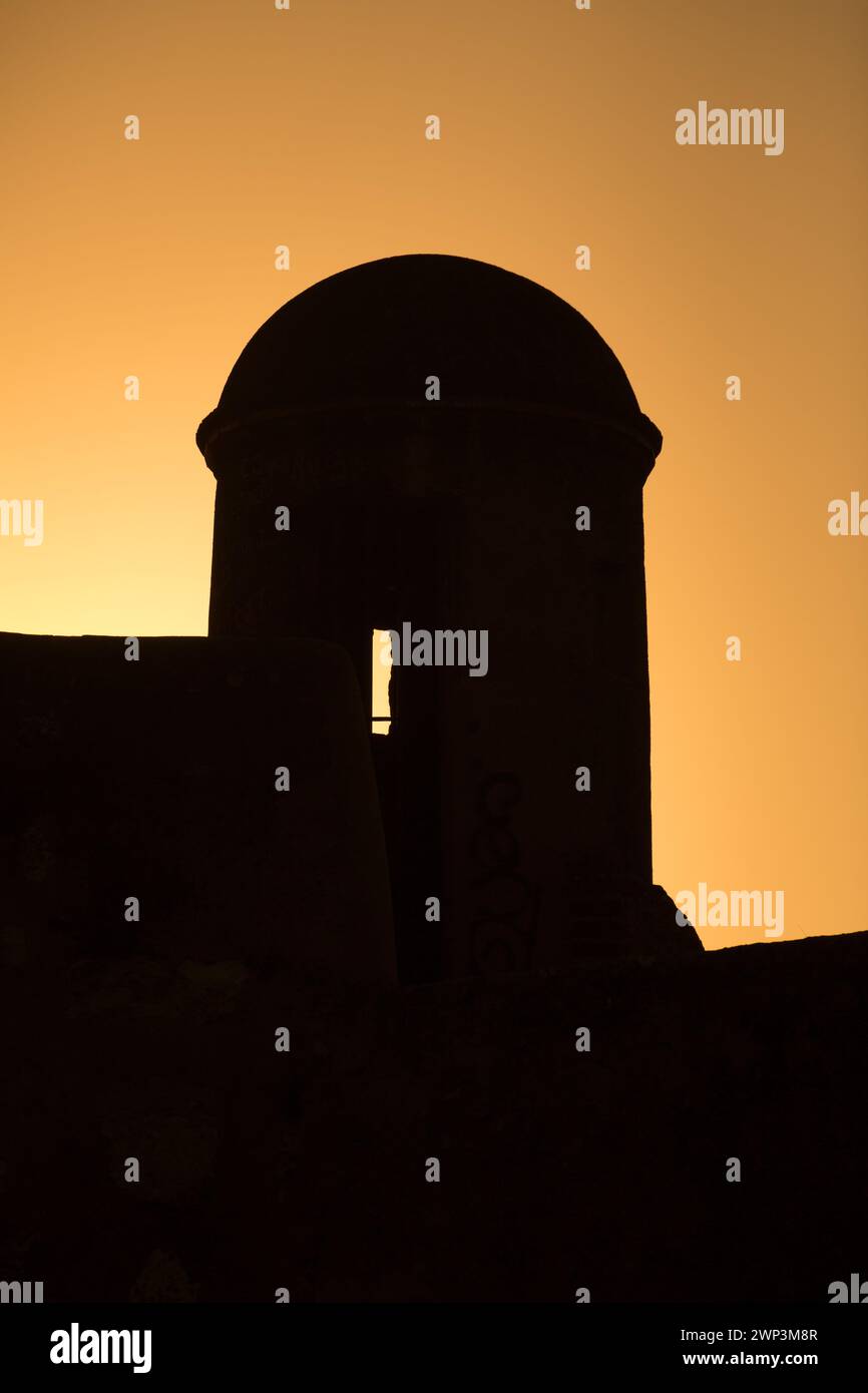 Sunrise silhouette of a guerite or sentry box on the city wall of the ...