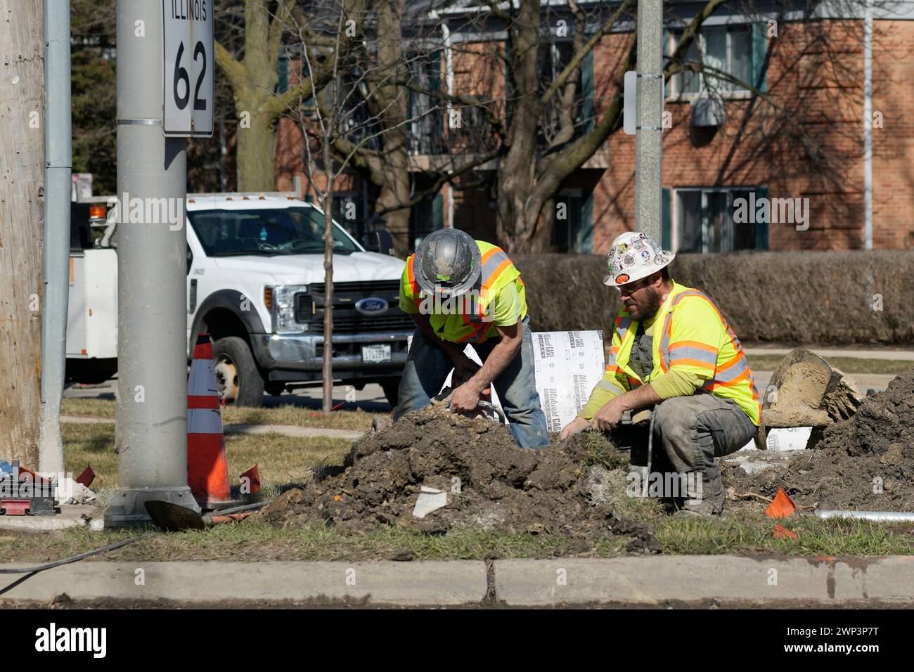 Construction workers work in Mount Prospect, Ill., Monday, Feb. 26 ...
