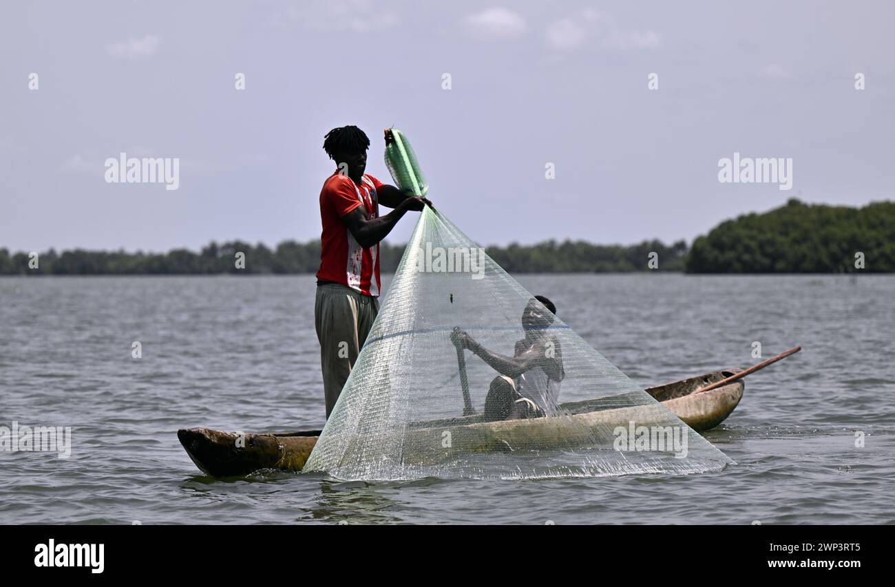 Abidjan, Ivory Coast. 05th Mar, 2024. A boat with two young fishermen ...