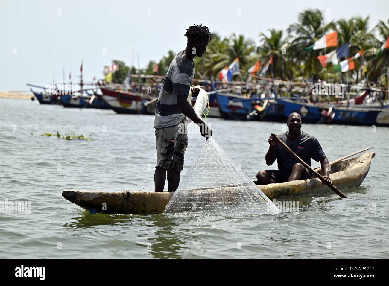 Abidjan, Ivory Coast. 05th Mar, 2024. A boat with two young fishermen ...