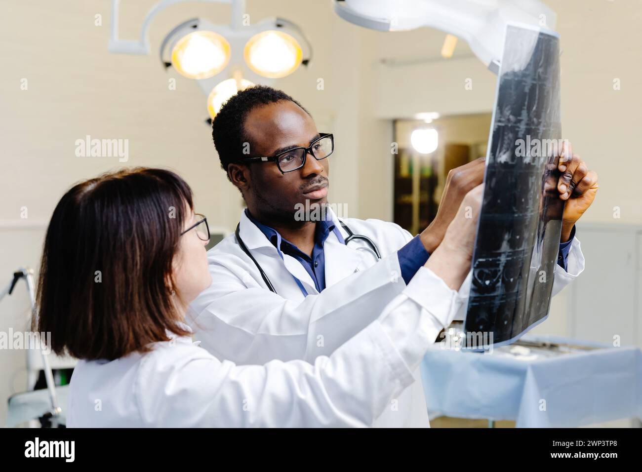 Man and woman in white lab coats conducting experiment Stock Photo - Alamy