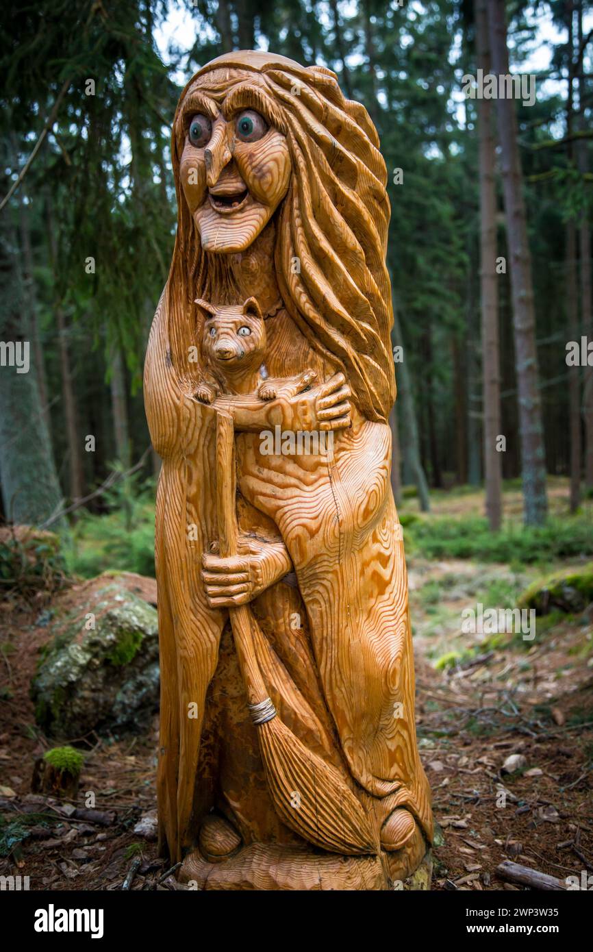 Wooden figure of a witch and her cat in the "haunted forest ...