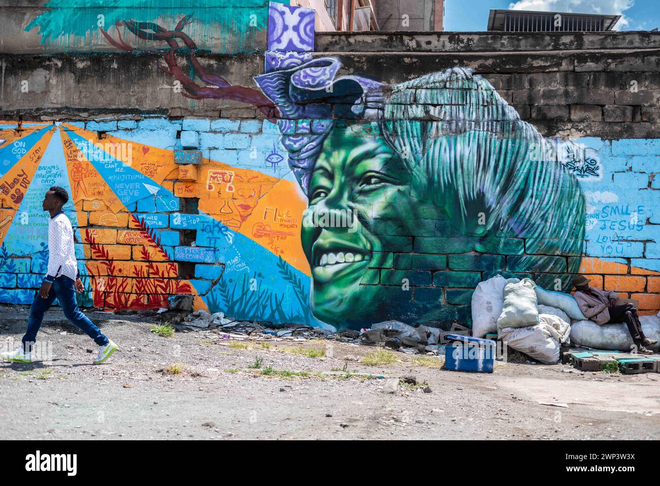 Nakuru, Kenya. 5th Mar, 2024. A man walks past a mural of the late ...