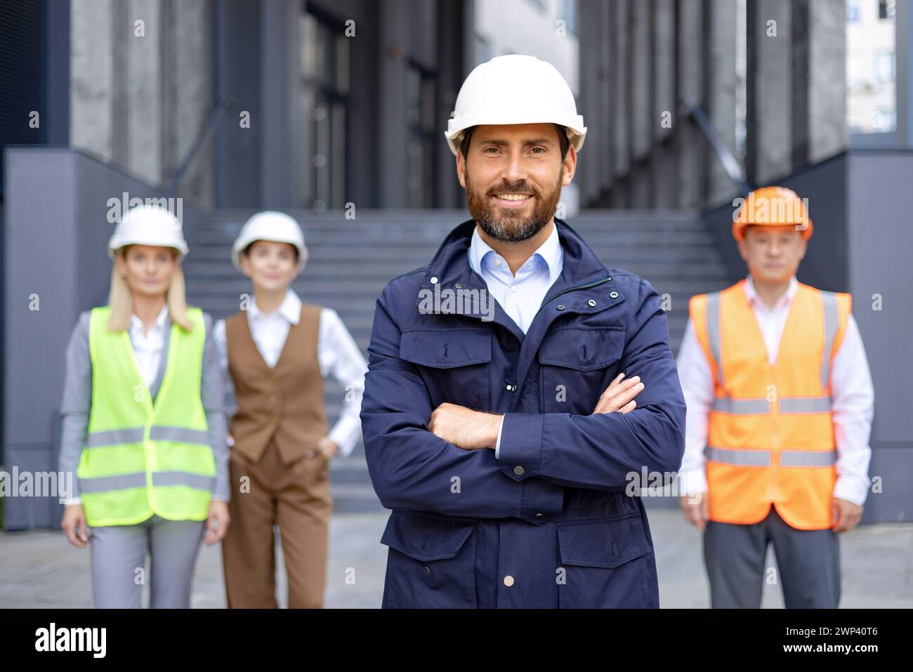 Professional male architect smiling in hard hat with diverse ...