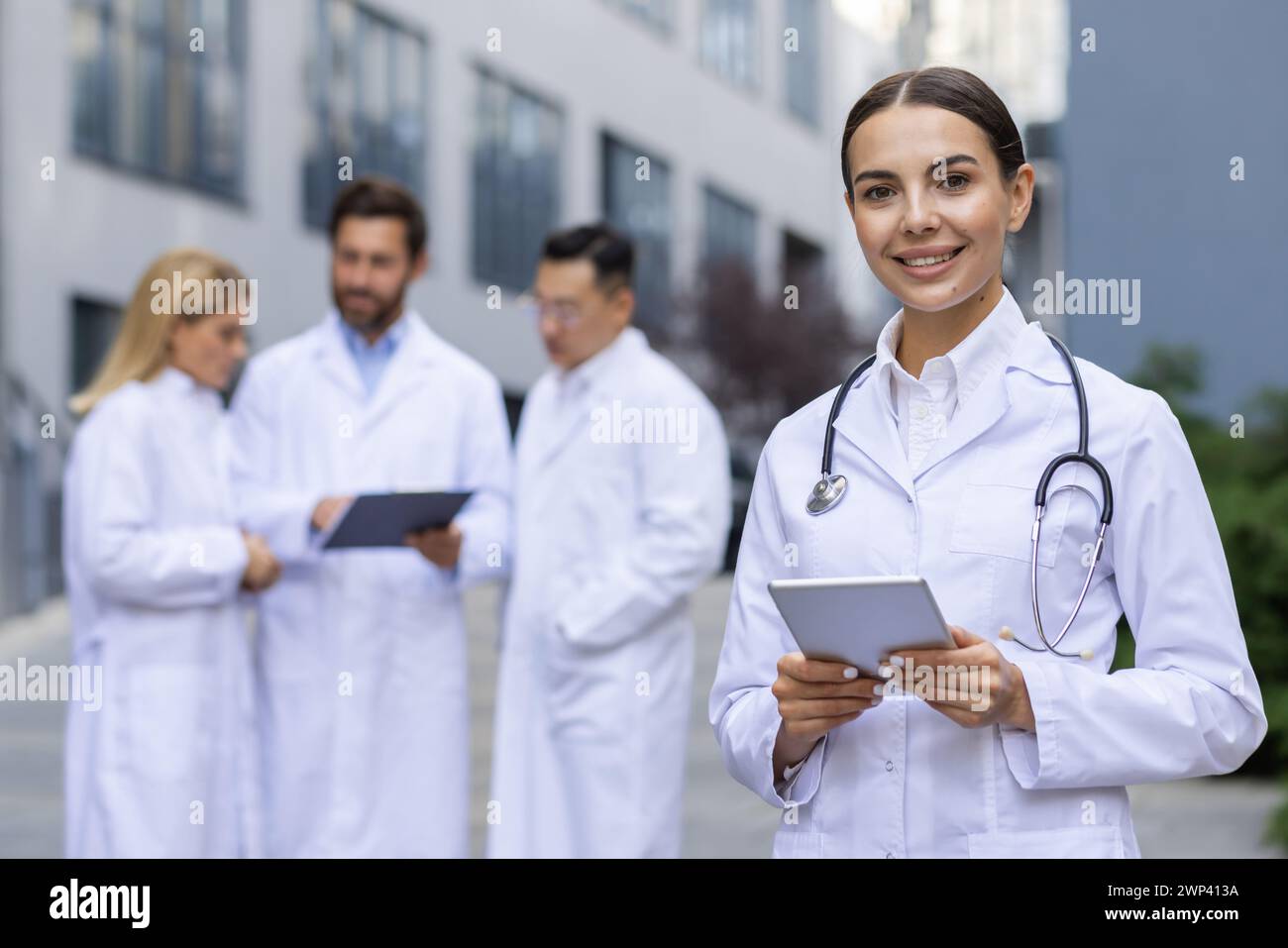 Professional female doctor with stethoscope standing confidently ...