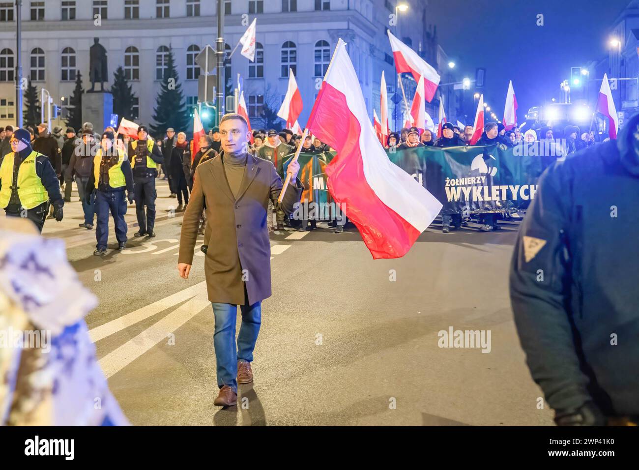 Robert Bakiewicz holds the Polish flag during March of Remembrance of ...