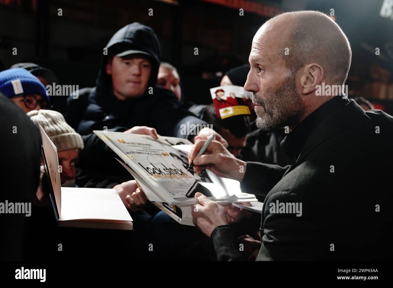 Jason Statham signs autographs for fans as he attends the premiere of ...