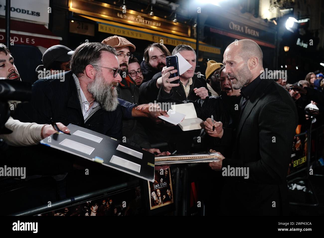 Jason Statham signs autographs for fans as he attends the premiere of ...