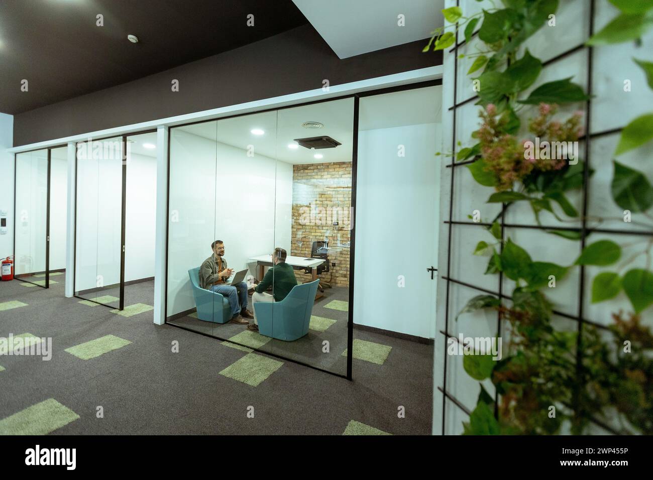 Two professionals engage in a conversation while seated comfortably in ...