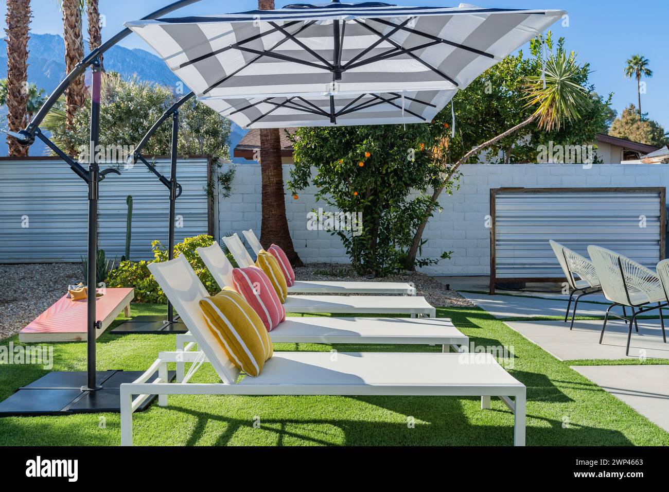 Backyard outdoor chaise lounge chairs with cantilever umbrellas and ...