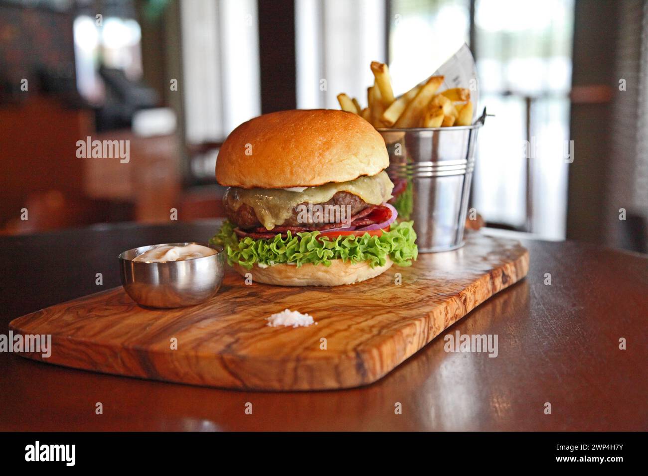 Cheers loaded Beef burger with fries Stock Photo - Alamy