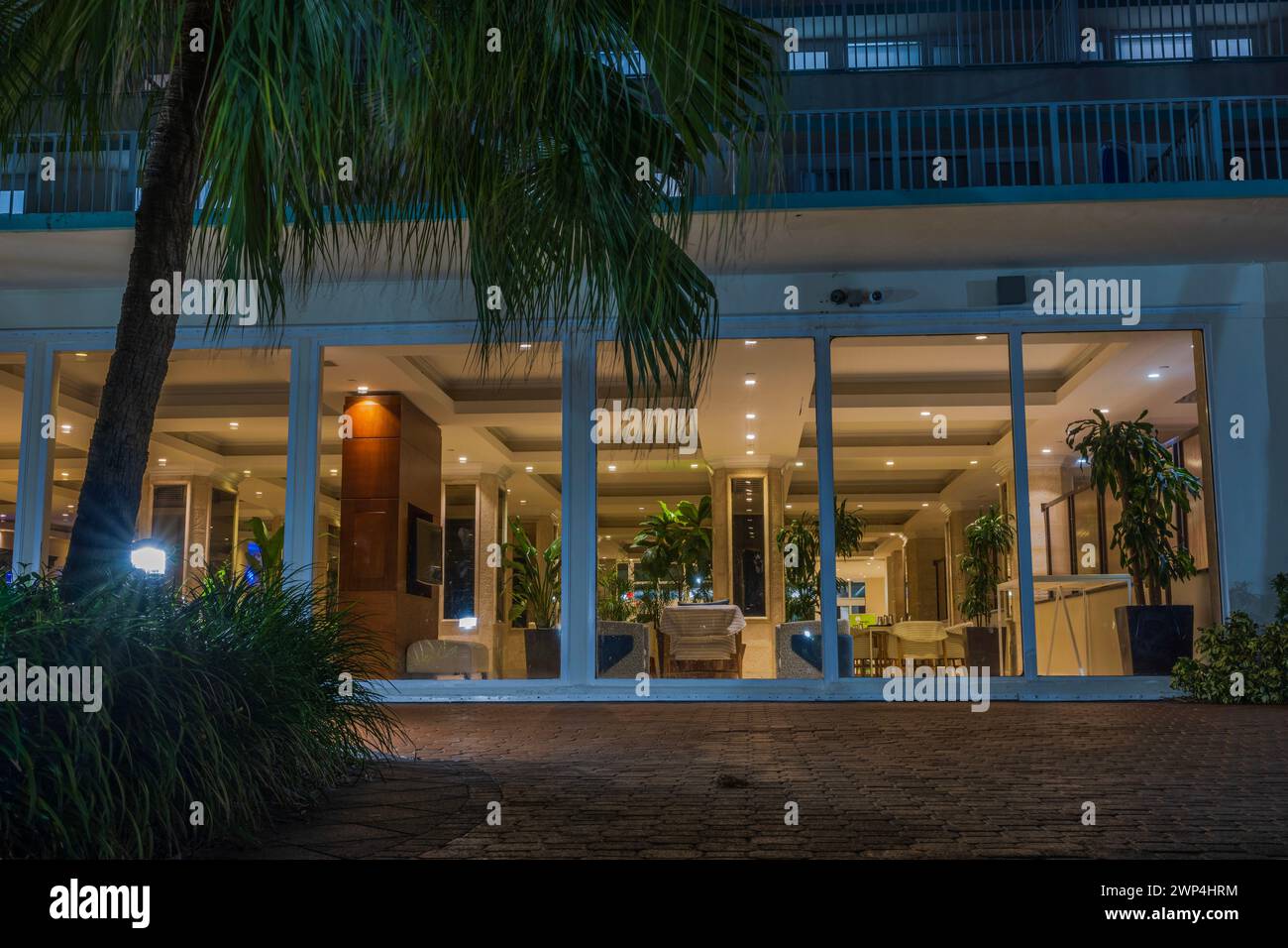 The view of a hotel lobby interior through a large showcase window ...