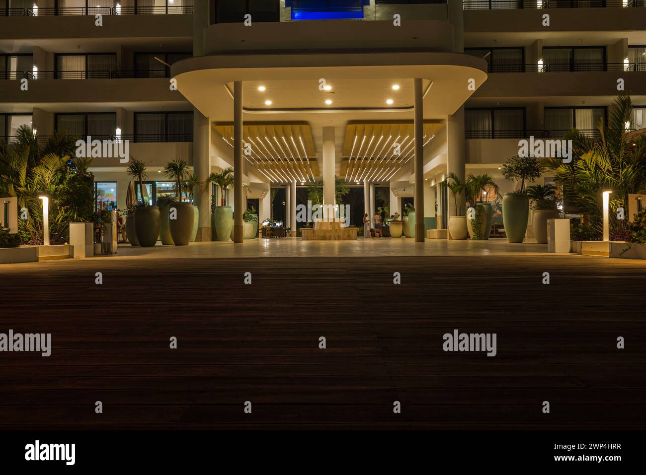 Beautiful view of hotel facade and grounds under canopy at night with ...