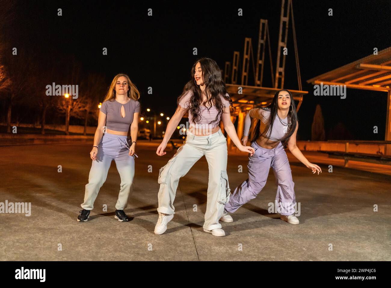 Group of three young freestyle dancers performing in the street at ...