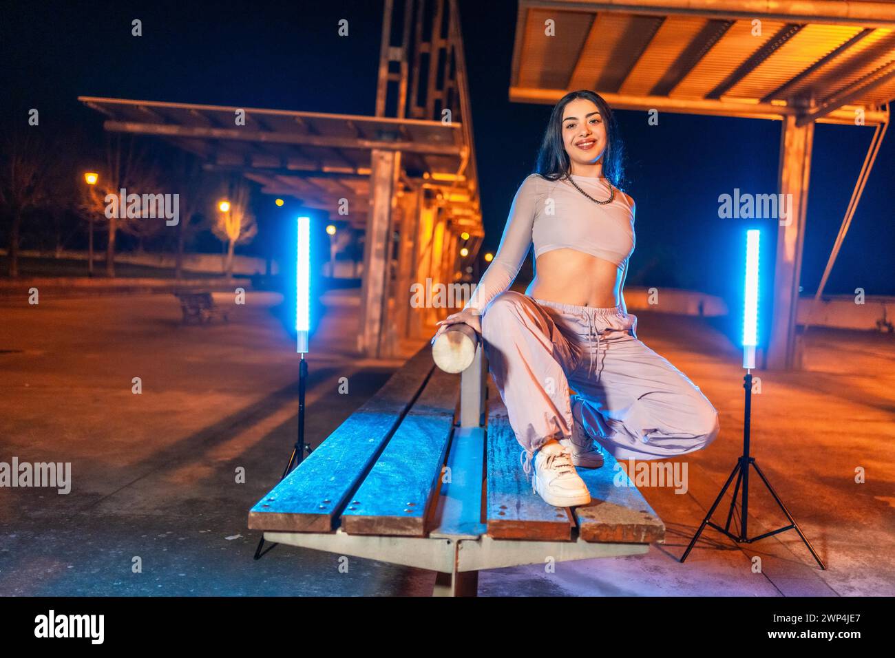 Portrait with copy space of a trap artist posing crouching in an urban ...