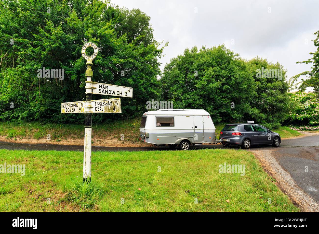 Old moss-covered signposts in the countryside, showing direction and ...