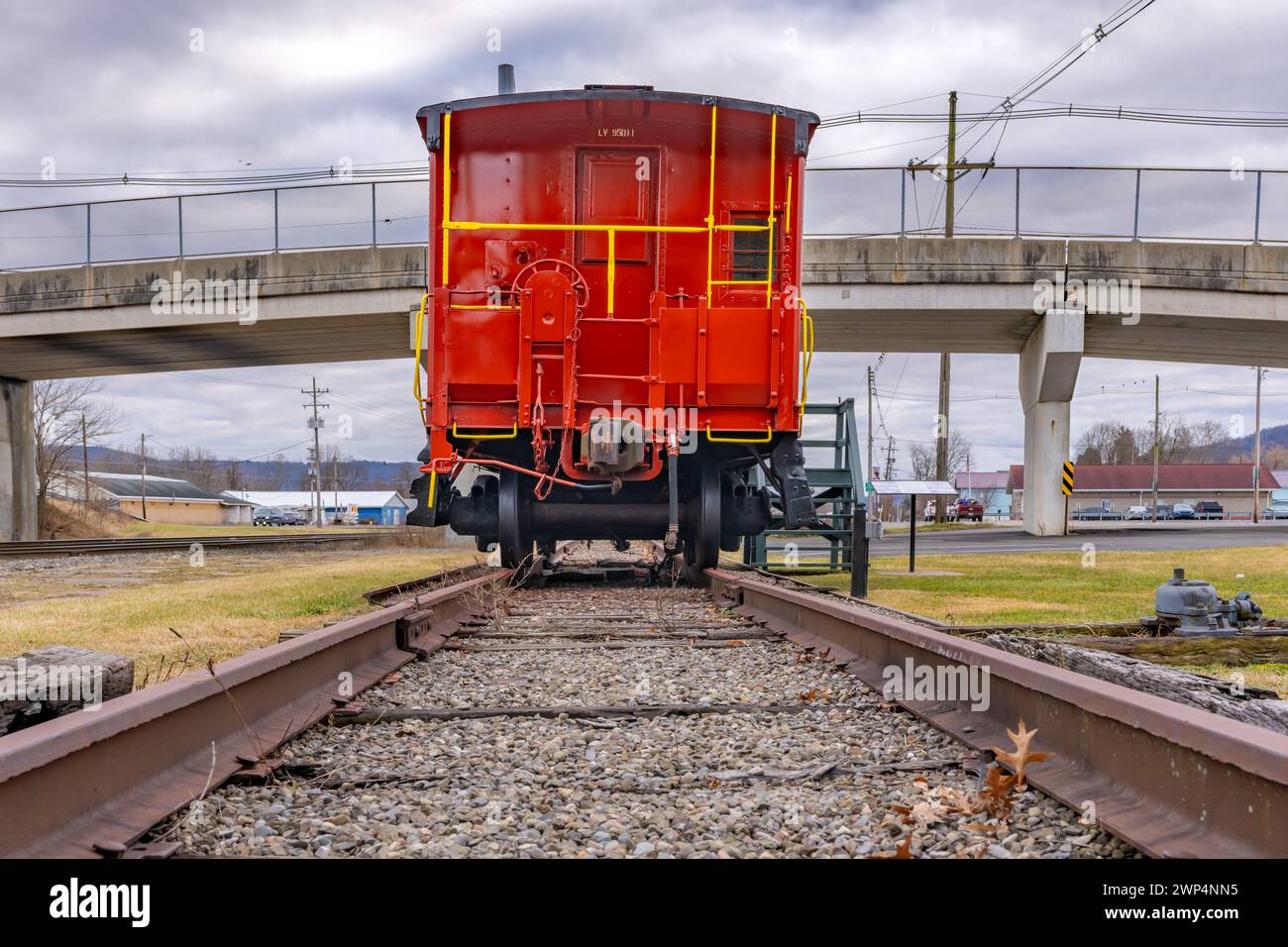 Close-up image of the end of a restored red vintage train, railroad, caboose including coupling ...