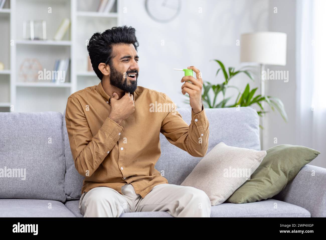 Unhealthy islamic man in shirt rubbing inflamed neck and looking at ...