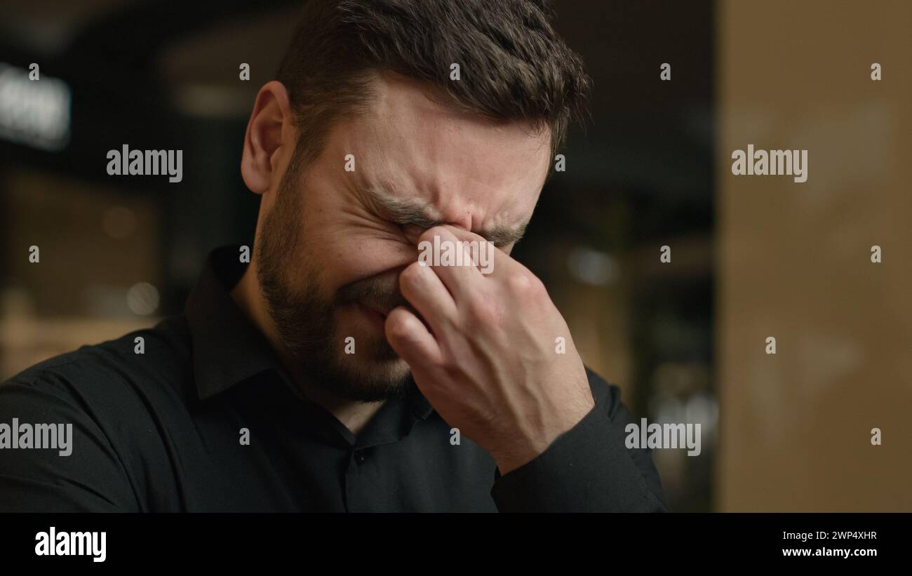 Close up anxious stressed Caucasian man tired upset guy rub dry ...