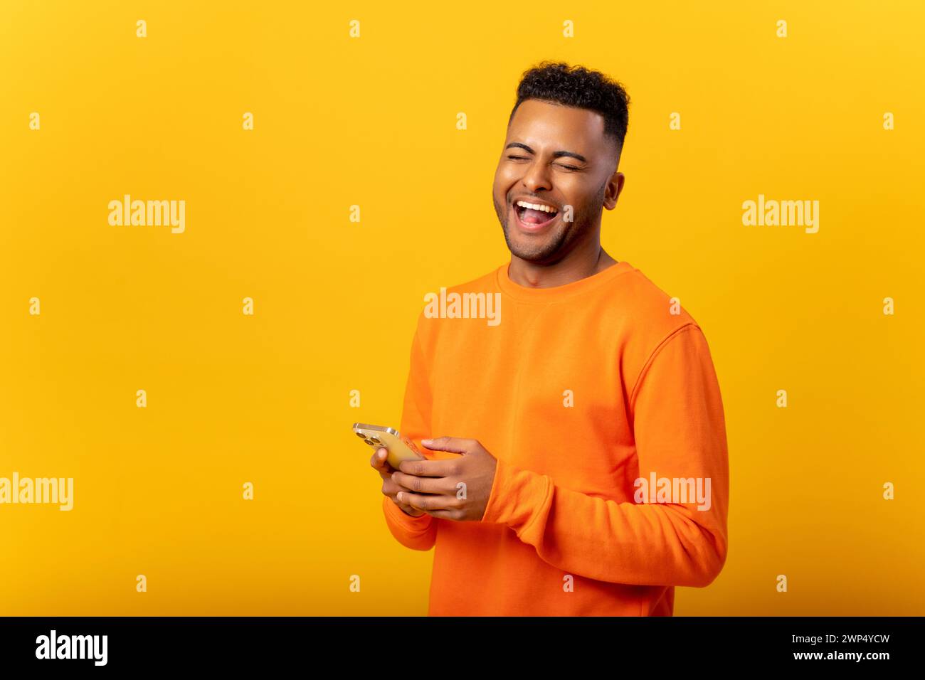 Optimistic indian man texting on the smartphone and laughing, smiling ...