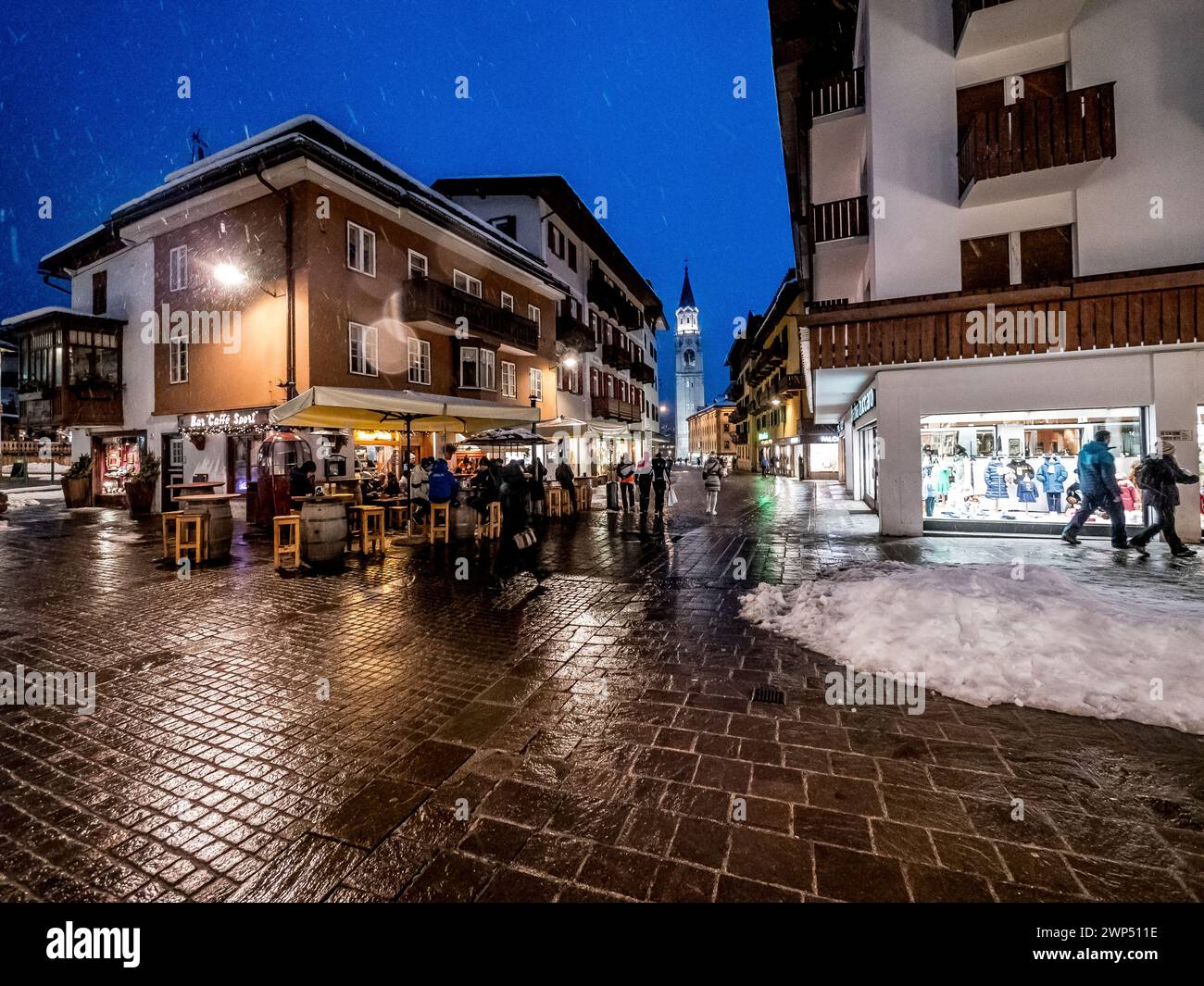 The image is of a winter night-time street scene in the resort town of ...