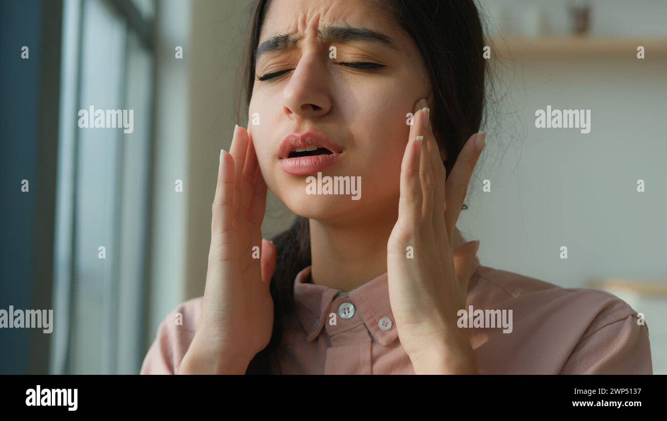 Tired sick woman arabian indian girl near window at home suffer from ...