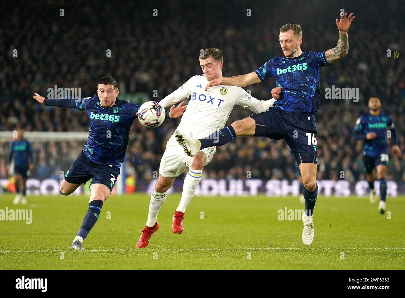 Leeds United's Patrick Bamford (centre) battles for the ball with Stoke ...