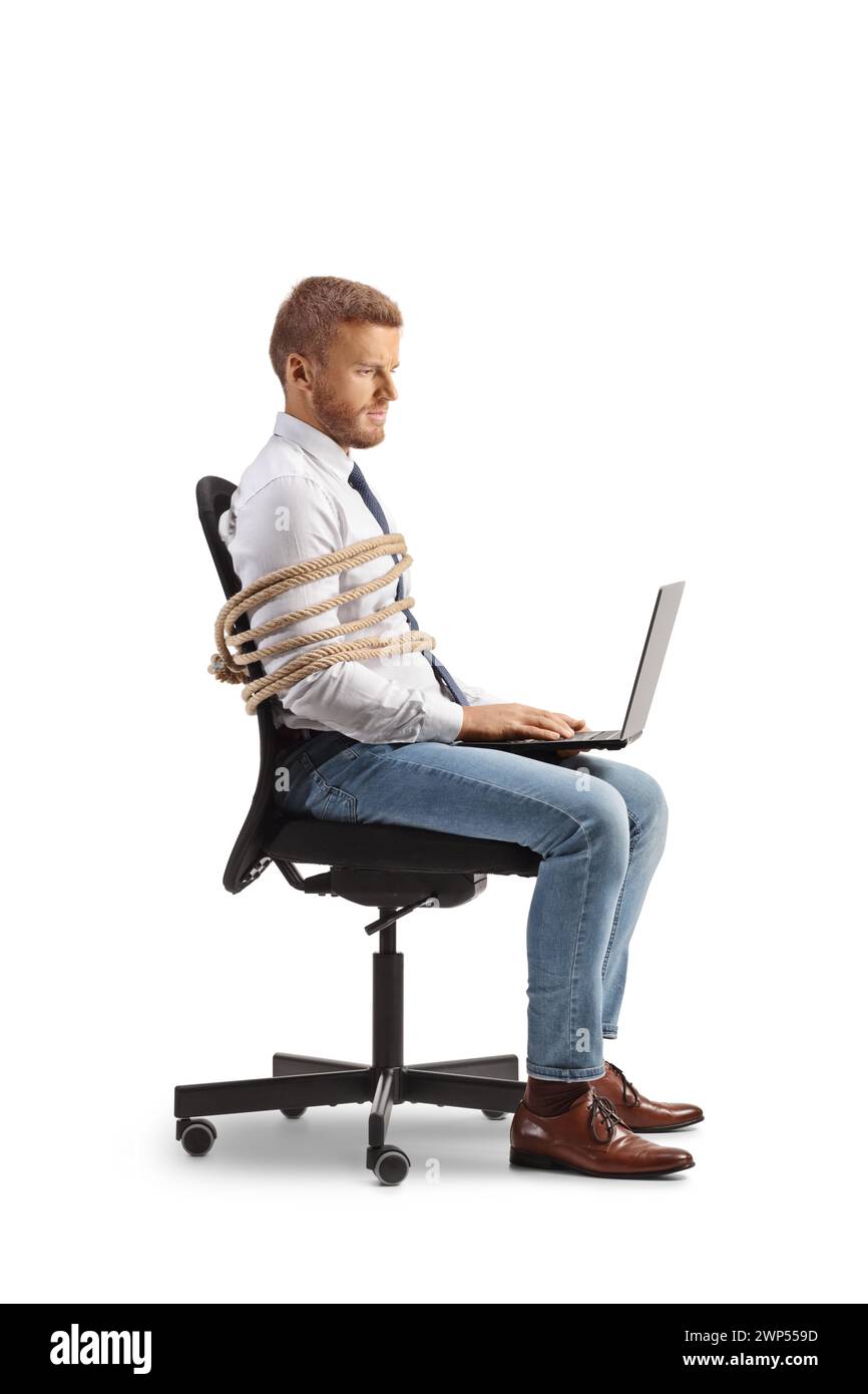 Profile shot of a male office worker sitting in chair tied with a rope ...
