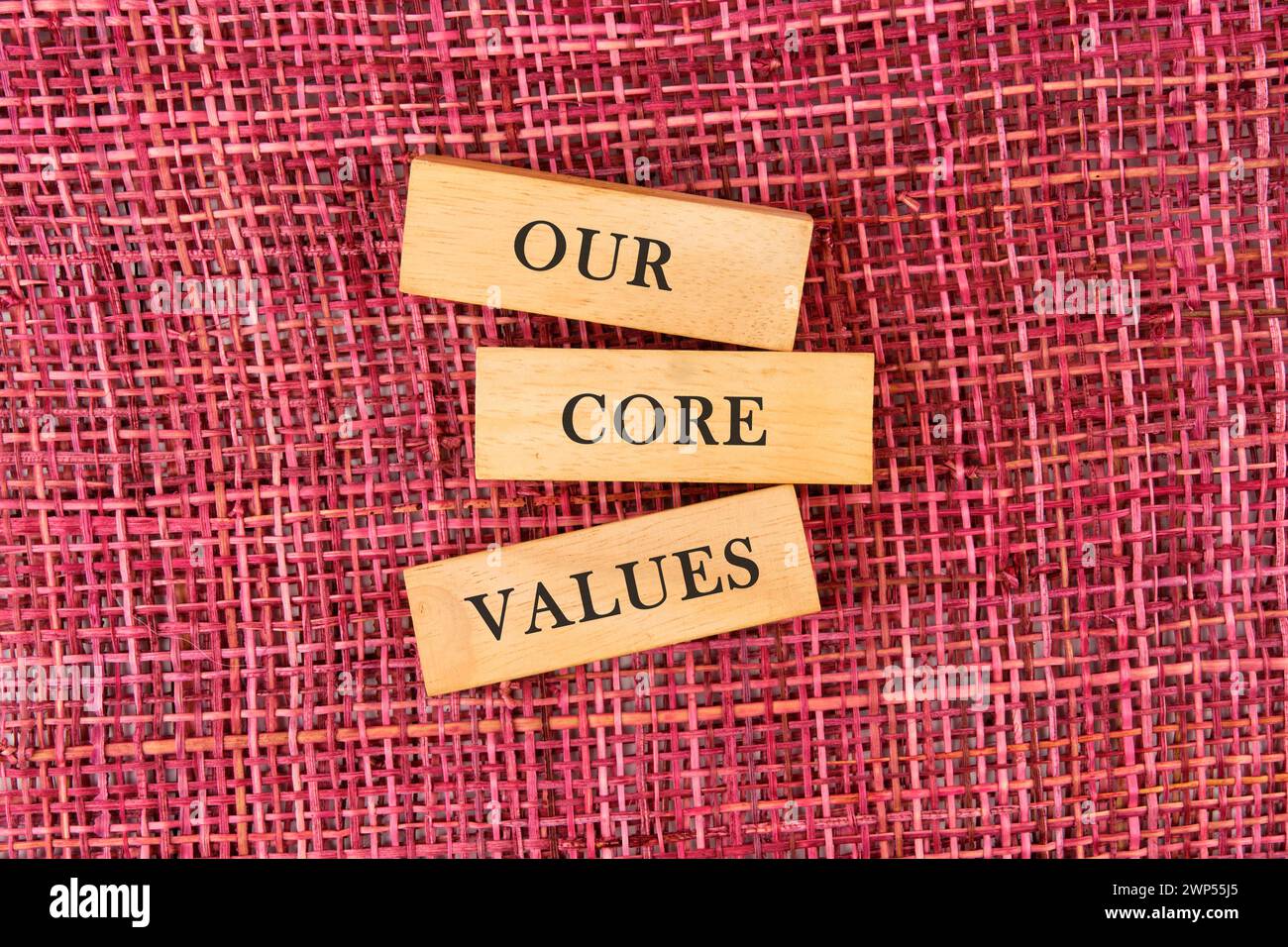 Concept words OUR CORE VALUES symbol on wooden blocks on a mesh ...