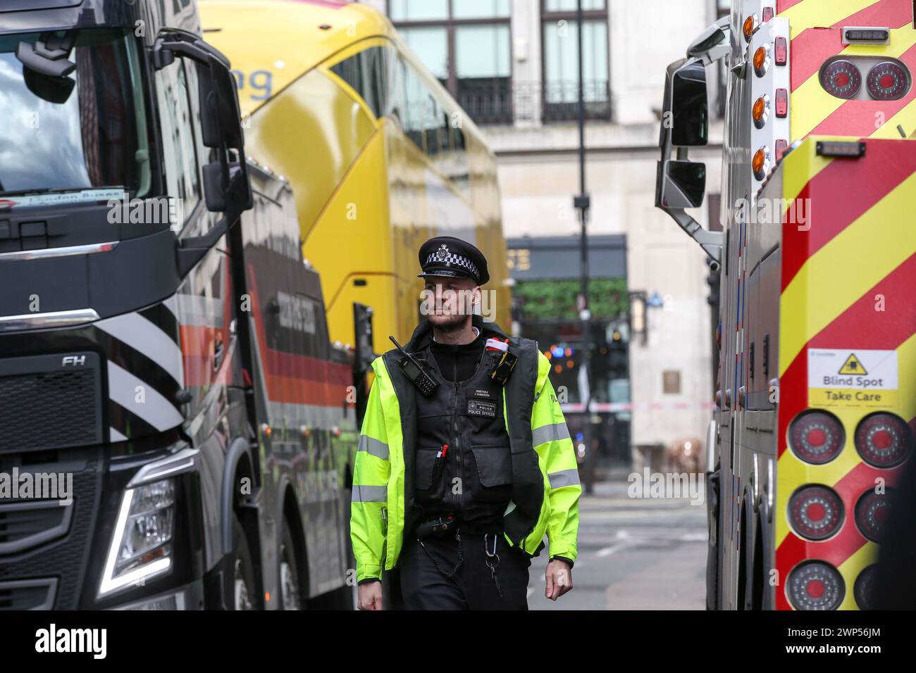 A police officer guards a London bus which crashed into All One Bar on ...